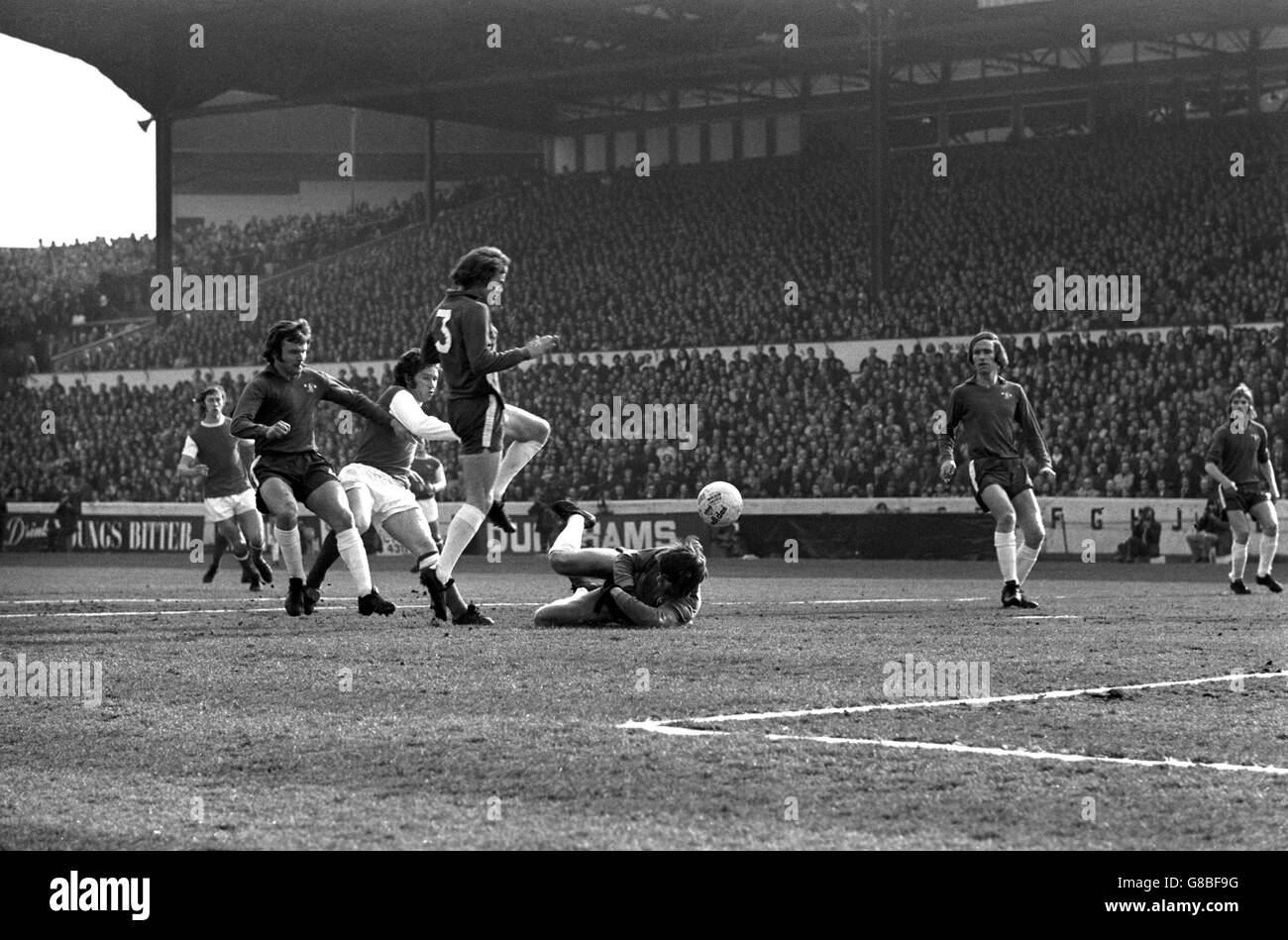 Chelsea goalkeeper John Phillips dives at the feet of Alan Ball ...