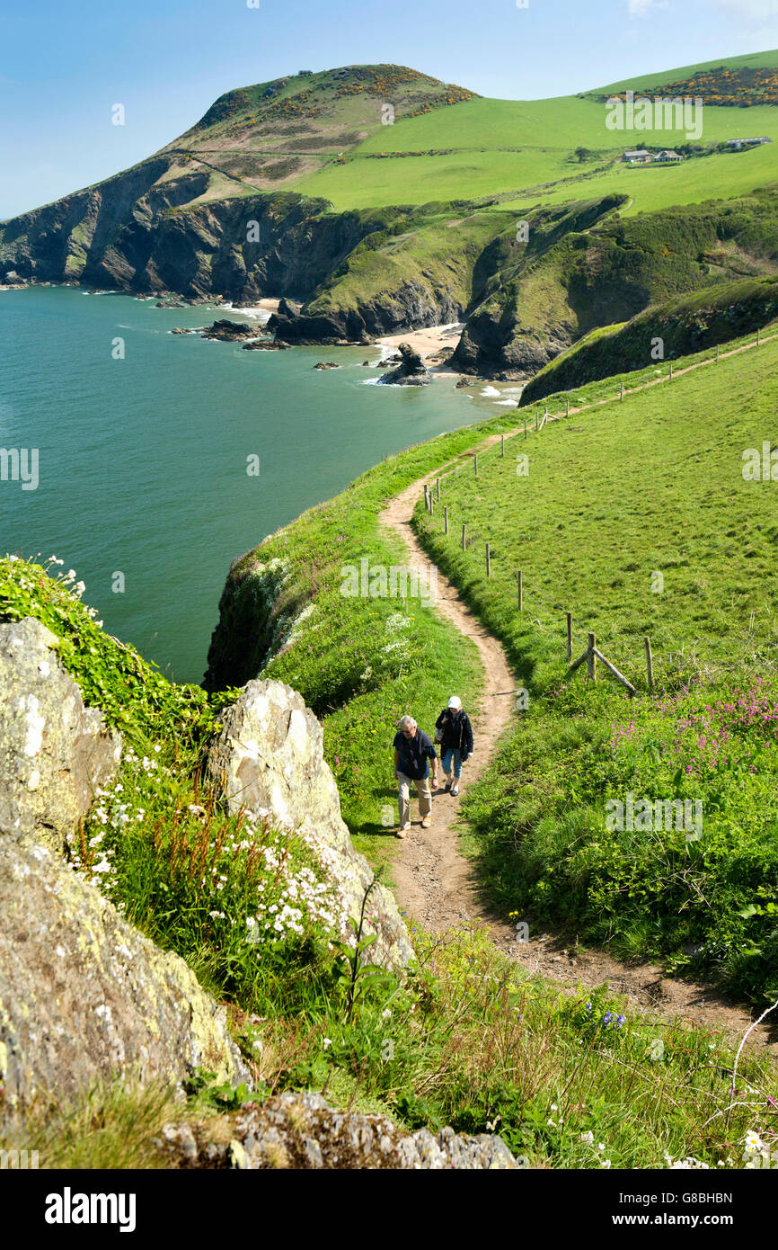 UK, Wales, Ceredigion, Llangrannog, couple walking on clifftop coast ...
