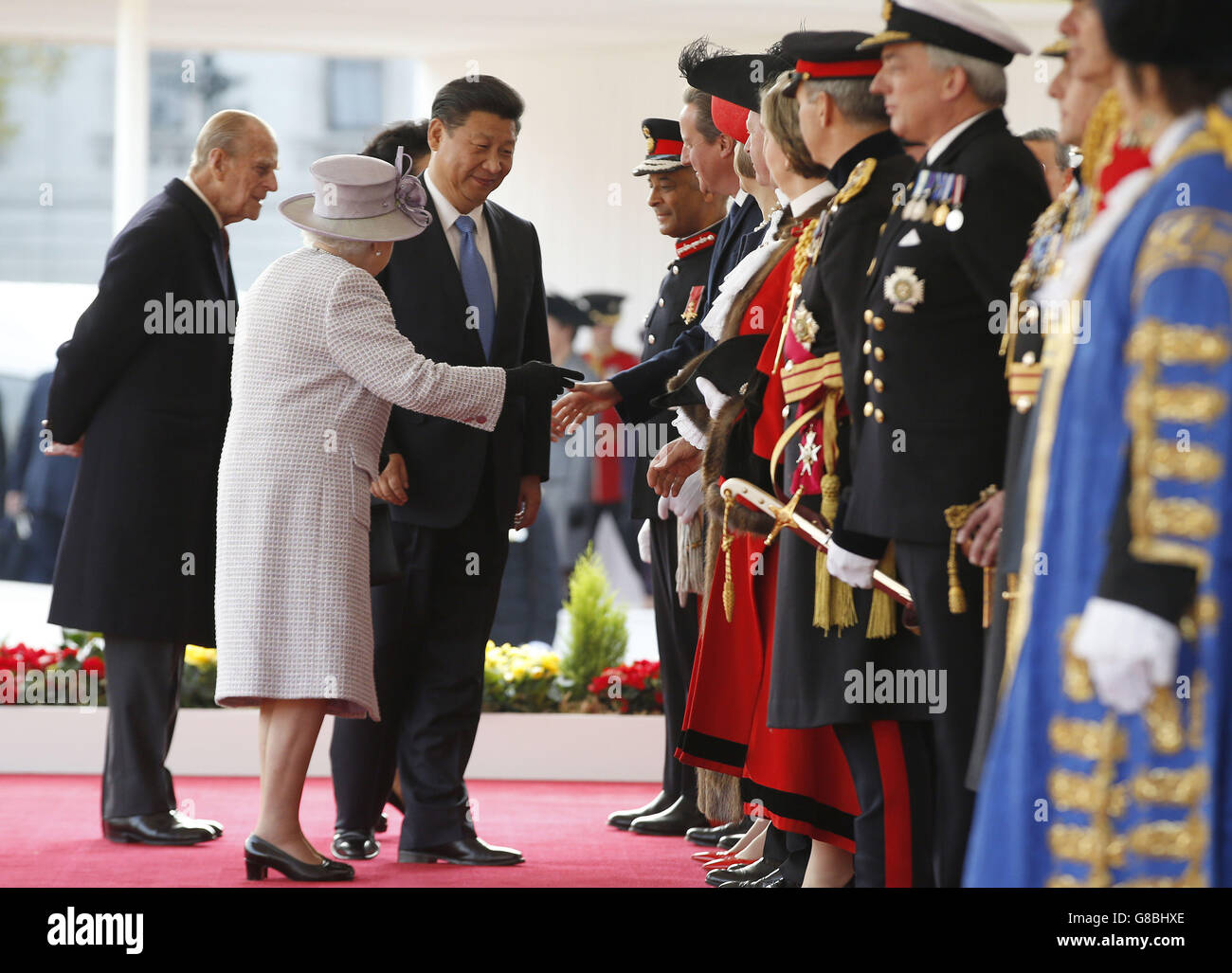 Queen Elizabeth II (second left) introduces the Chinese President Xi ...