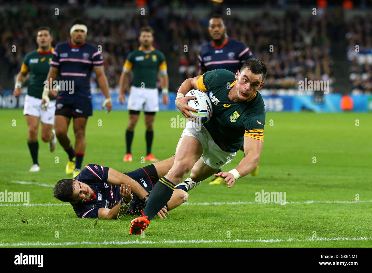 South Africa's Jesse Kriel skips past USA's Niko Kruger (left) to score ...