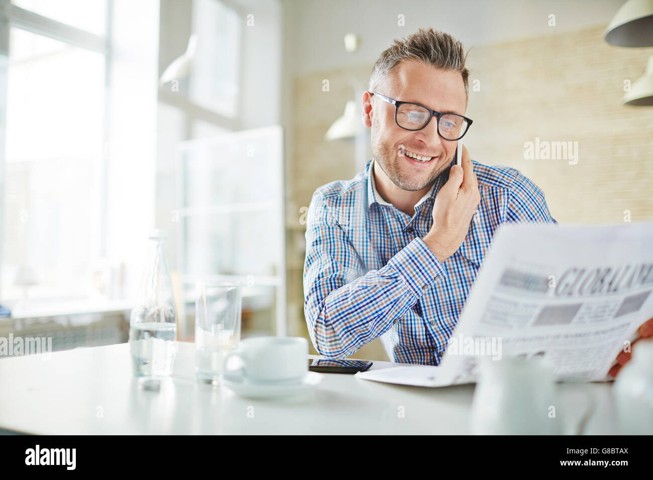 Reading newspaper article Stock Photo - Alamy