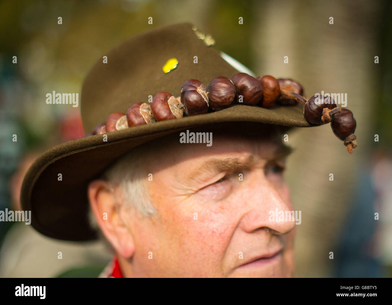 An official wears a hat decorated with conkers at the 50th World Conker ...
