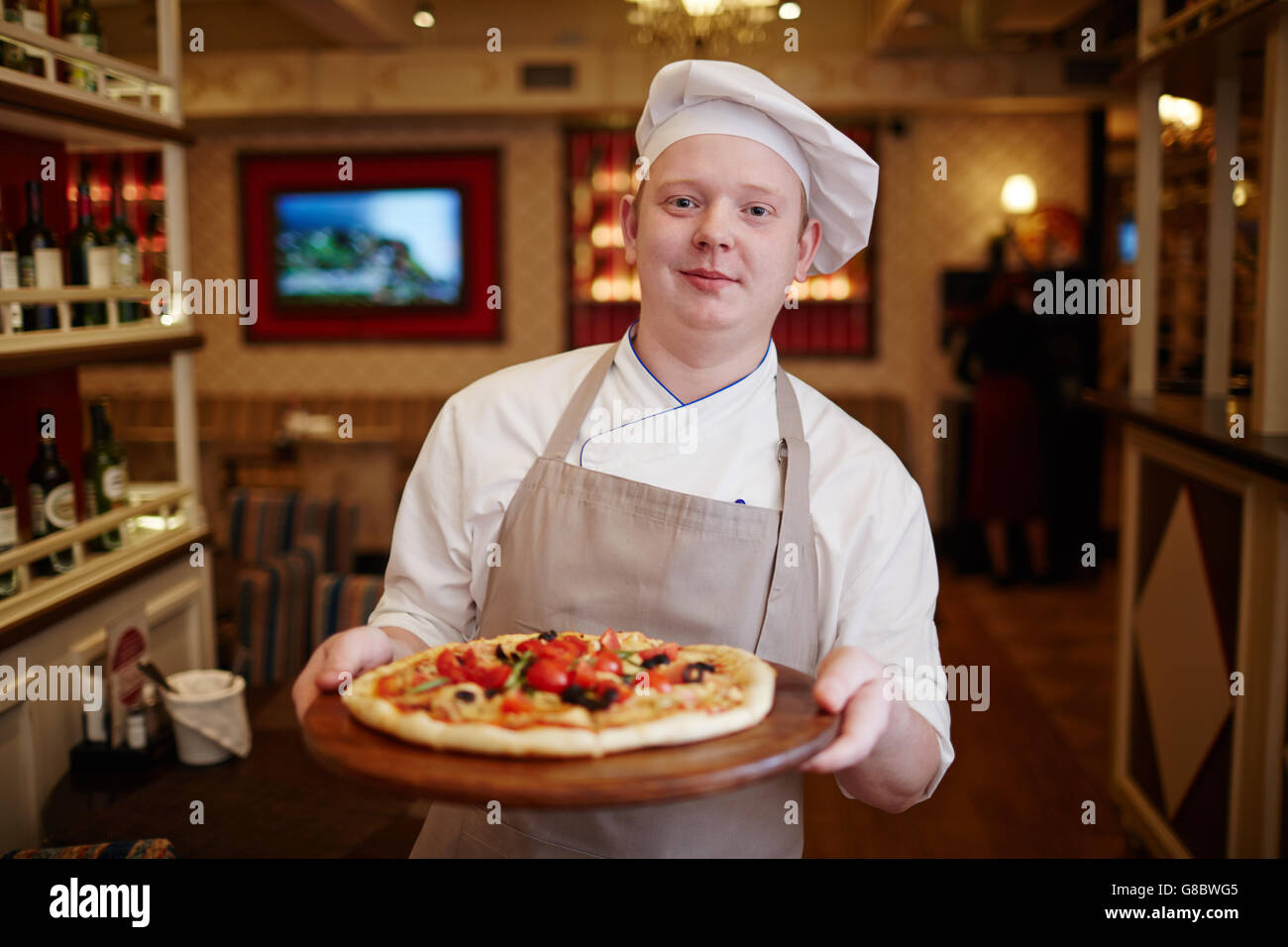 Chef with pizza Stock Photo - Alamy