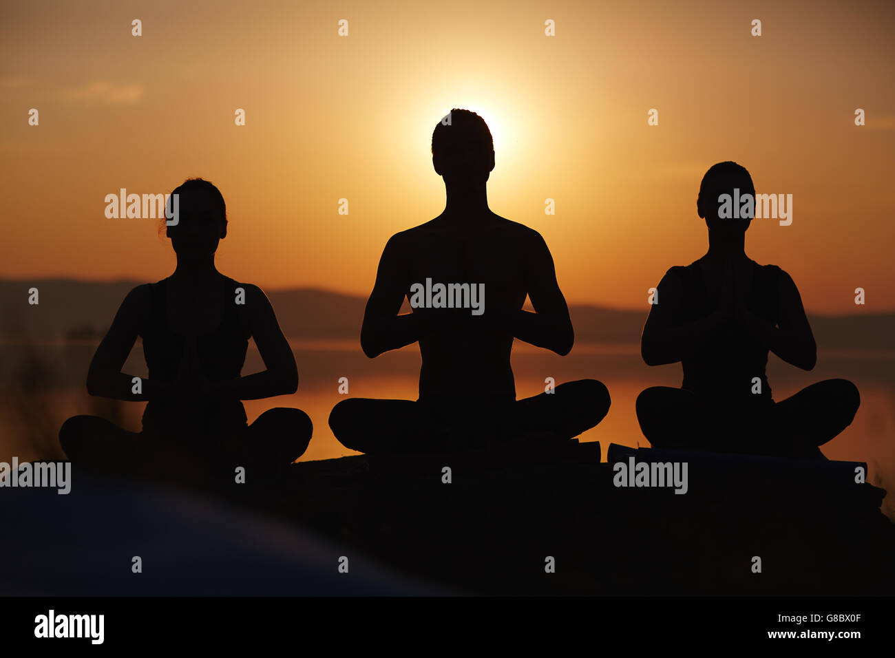 Yoga at sunset Stock Photo - Alamy