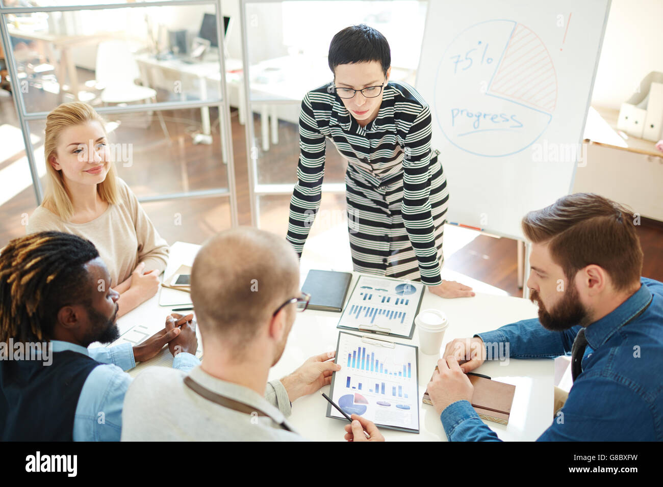 Discussing new project in office Stock Photo - Alamy