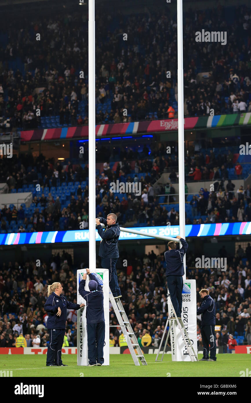 Ground staff take down the rugby posts after the match hi-res stock ...