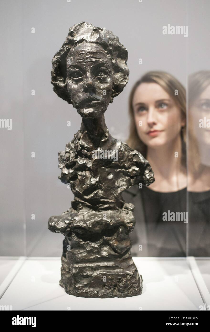 A gallery employee views Annette IV, a bronze bust made in 1962, during ...