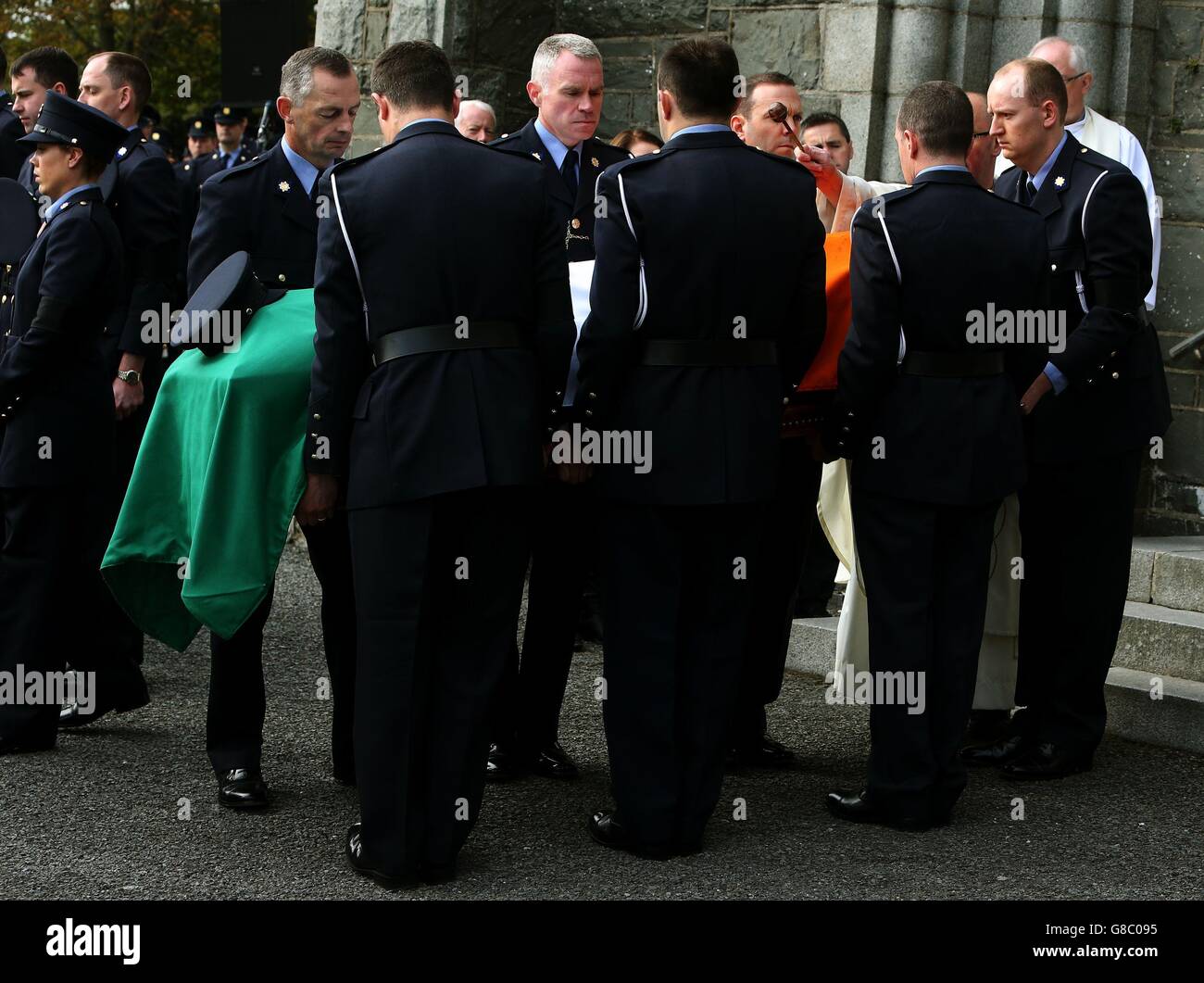 The coffin of Garda Tony Golden is carried into St Oliver Plunkett ...