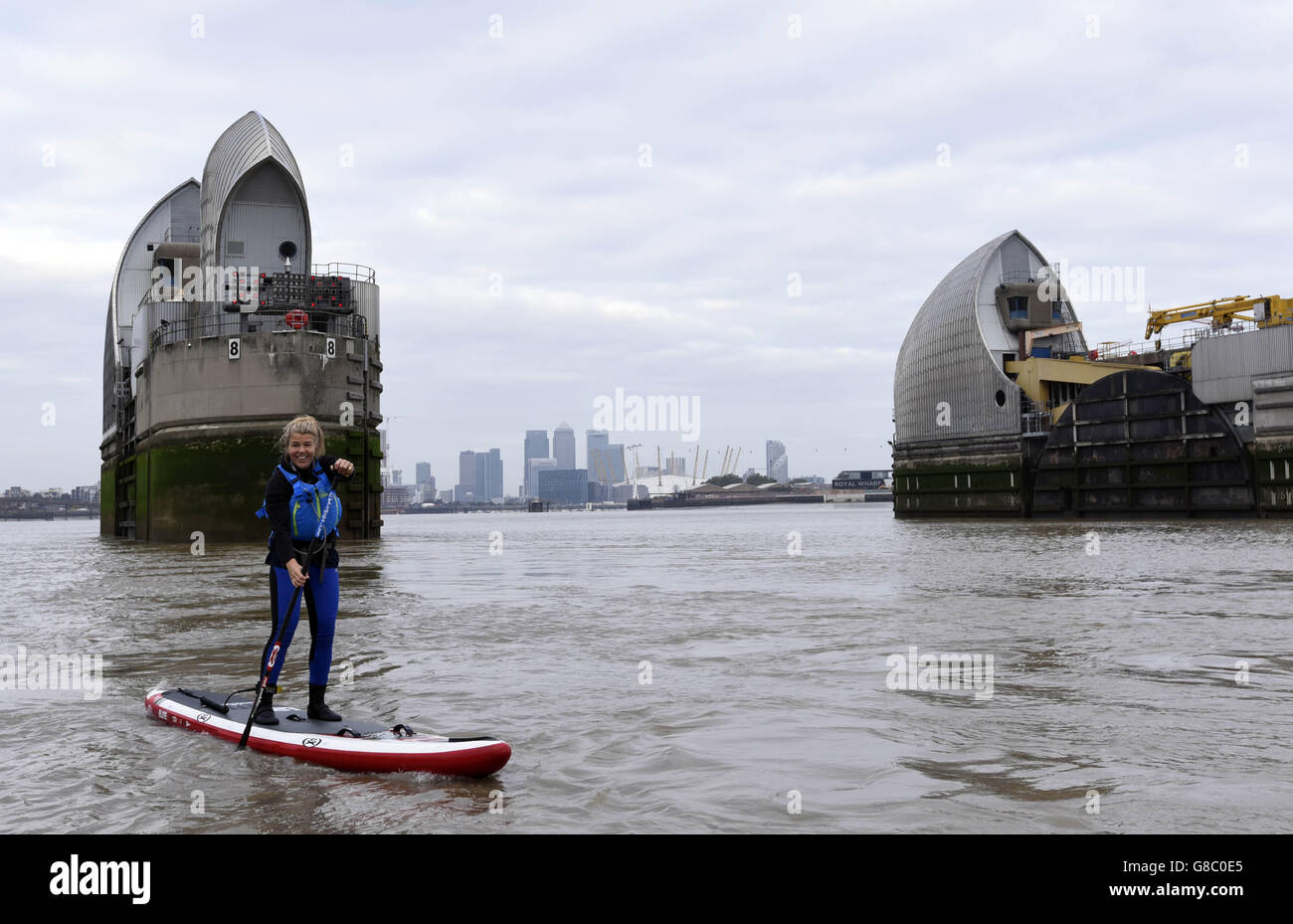 Amber Nuttall navigates her paddle board through the Thames Barrier in ...