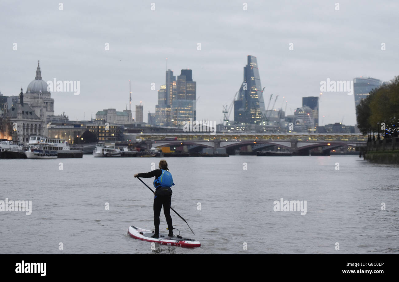 Amber Nuttall navigates her paddle board through central London as she ...