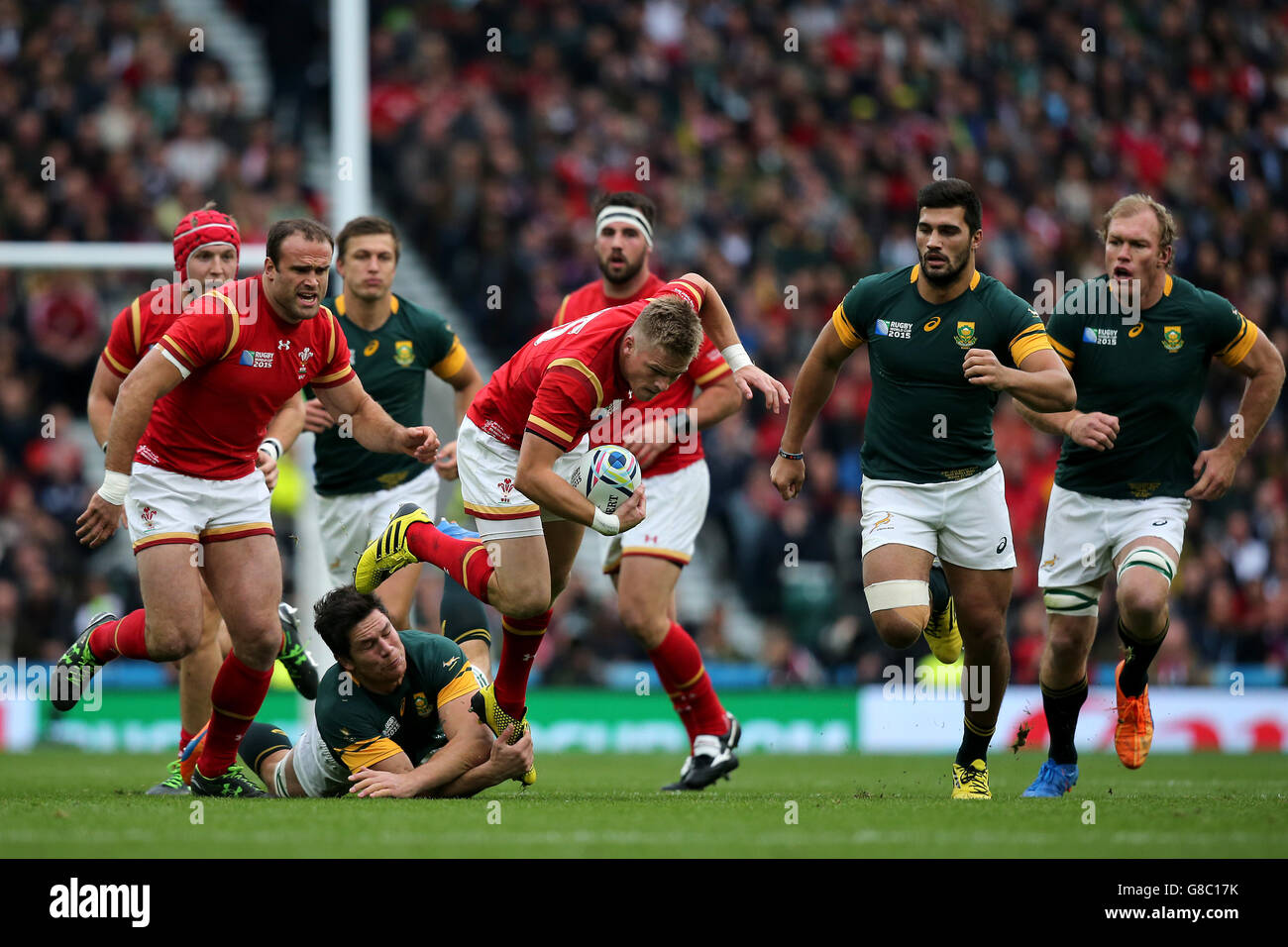 Wales' Gareth Anscombe (centre) gets away from a tackle during the ...