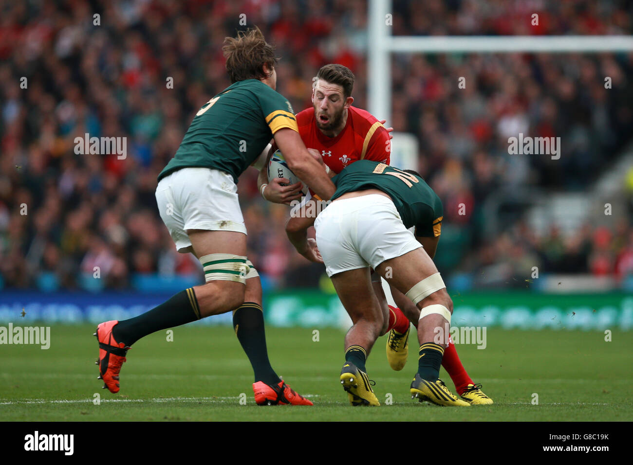Wales' Alex Cuthbert (centre) looks to break the tackle of South Africa ...