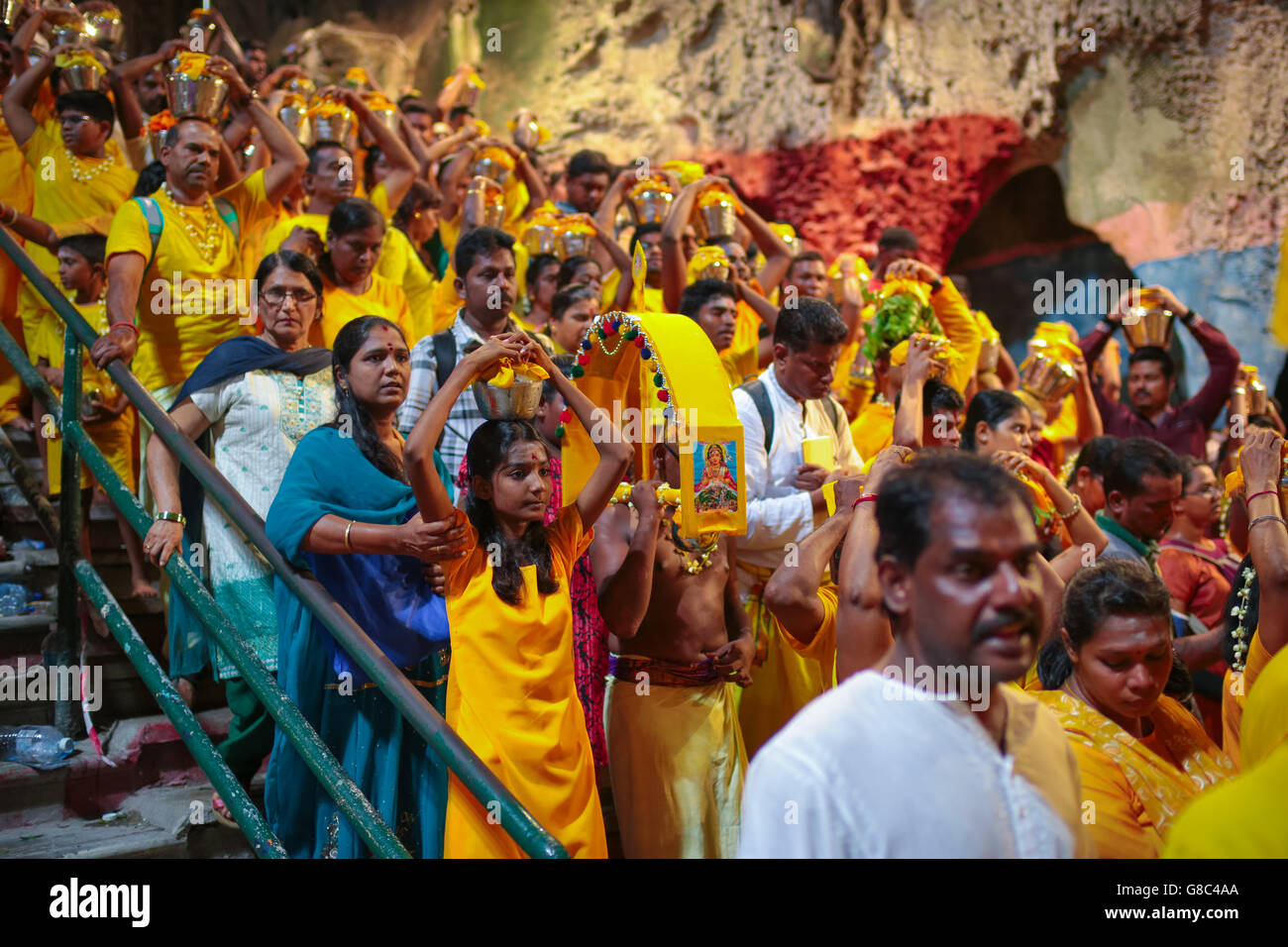 Hindu family carrying milk pot waiting inside Batu Cave to give ...