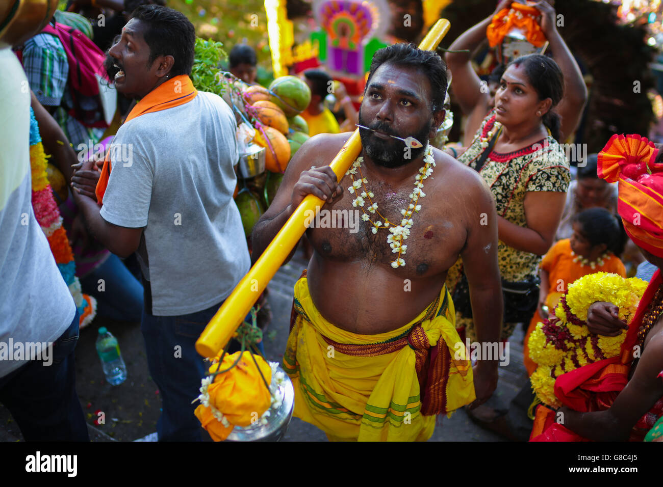 Pierced mouth kavadi bearer carry milk pot climb the Batu Cave temple ...