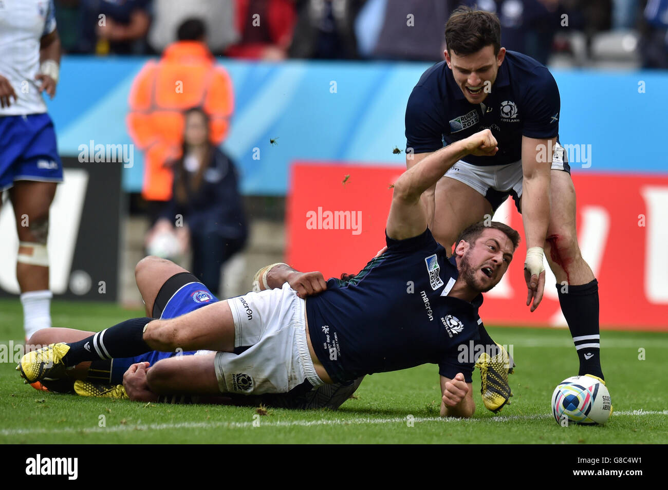 Scotland's Greig Laidlaw (floor) celebrates scoring their third try ...