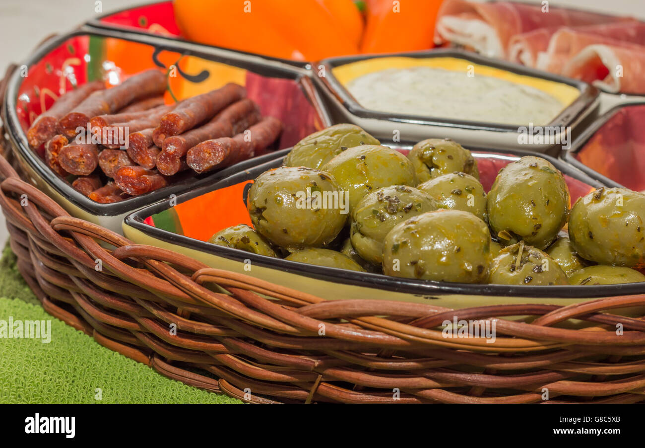 Basket with Spanish tapas, cured ham, olives, peppers and chorizo Stock ...