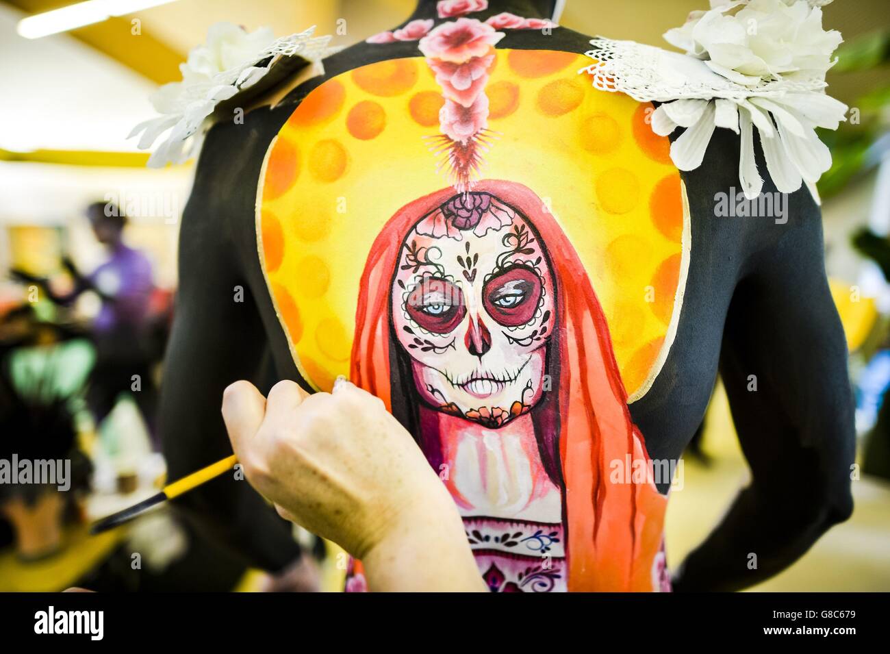 A model is painted in a Day of the Dead themed body art, during the ...