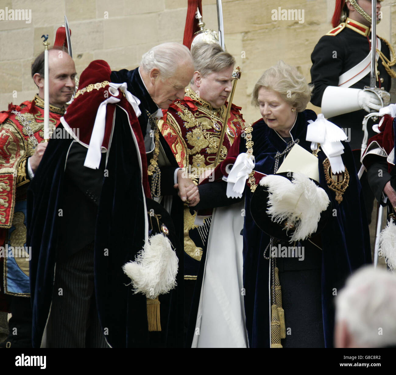 Former British Prime Minister Baroness Thatcher is helped down steps by ...