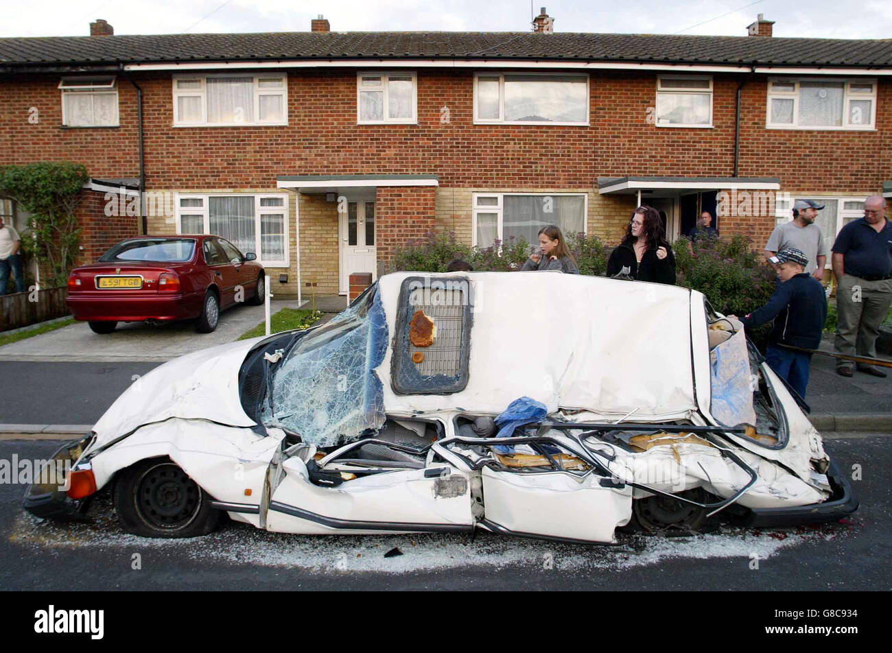 A recovery forklift removing one of the damaged cars from the scene ...