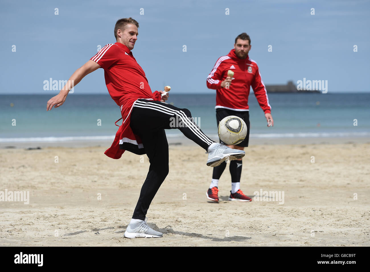 Wales' Sam Vokes and David Edwards (left) play football whilst eating ...
