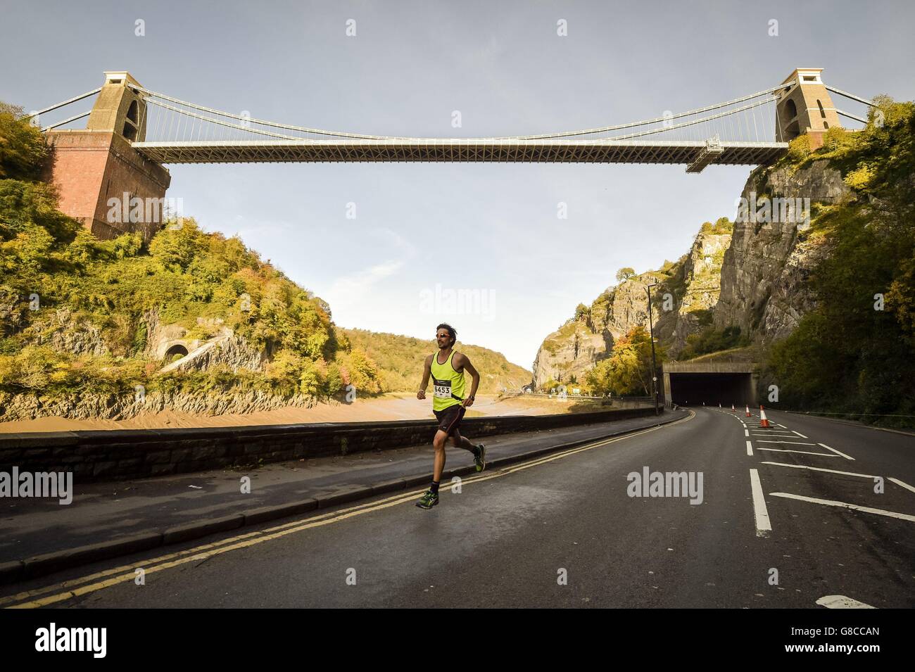 A lead runner goes past the Clifton Suspension Bridge as thousands of ...
