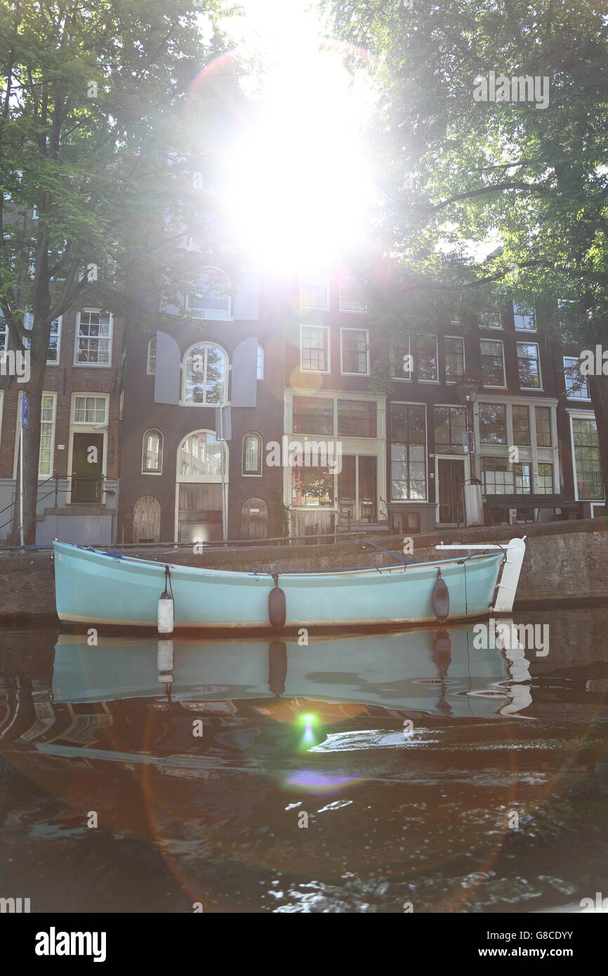 Blue boat in one of the canals of Amsterdam,Holland Stock Photo - Alamy
