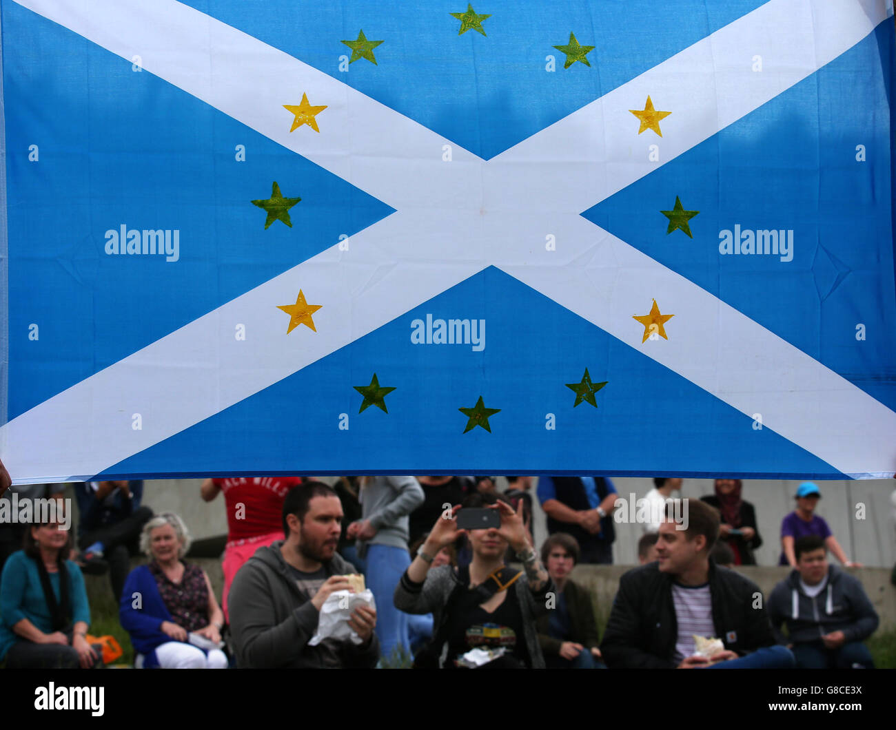 A Saltire flag decorated with stars representing the European Union is ...