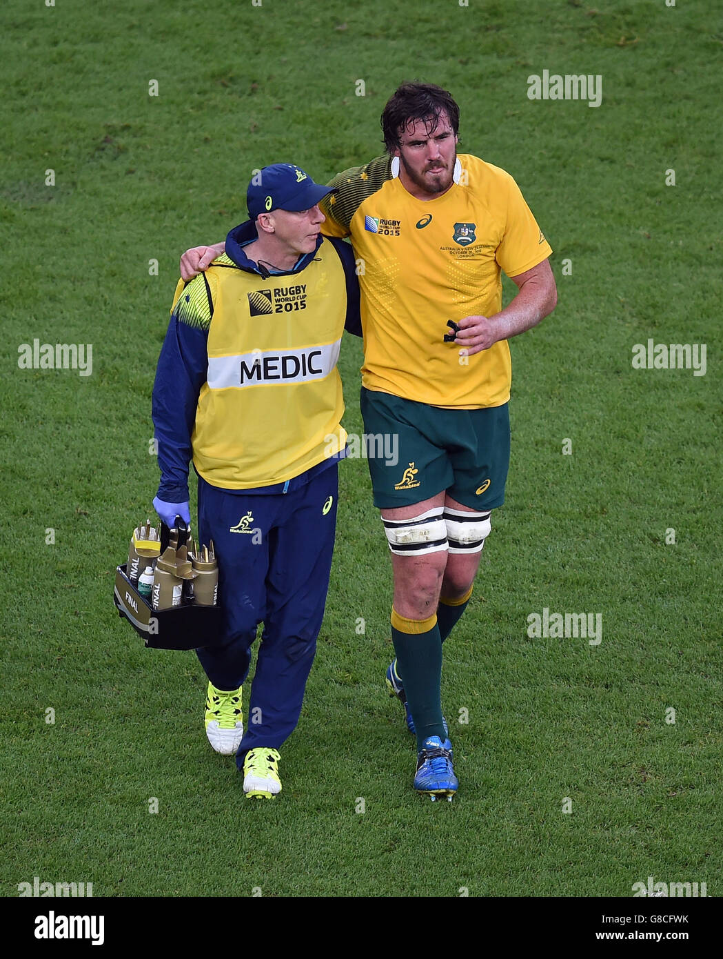 Australia's Kane Douglas (right) goes off with an injury during the ...