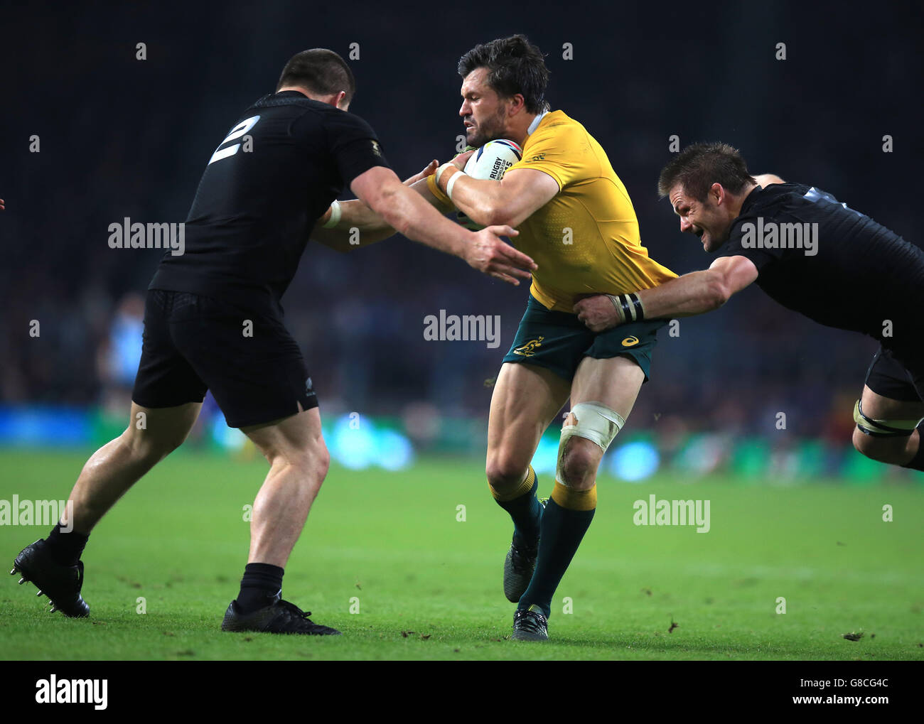 Australia's Adam Ashley-Cooper (centre) is tackled by New Zealand's Dan ...