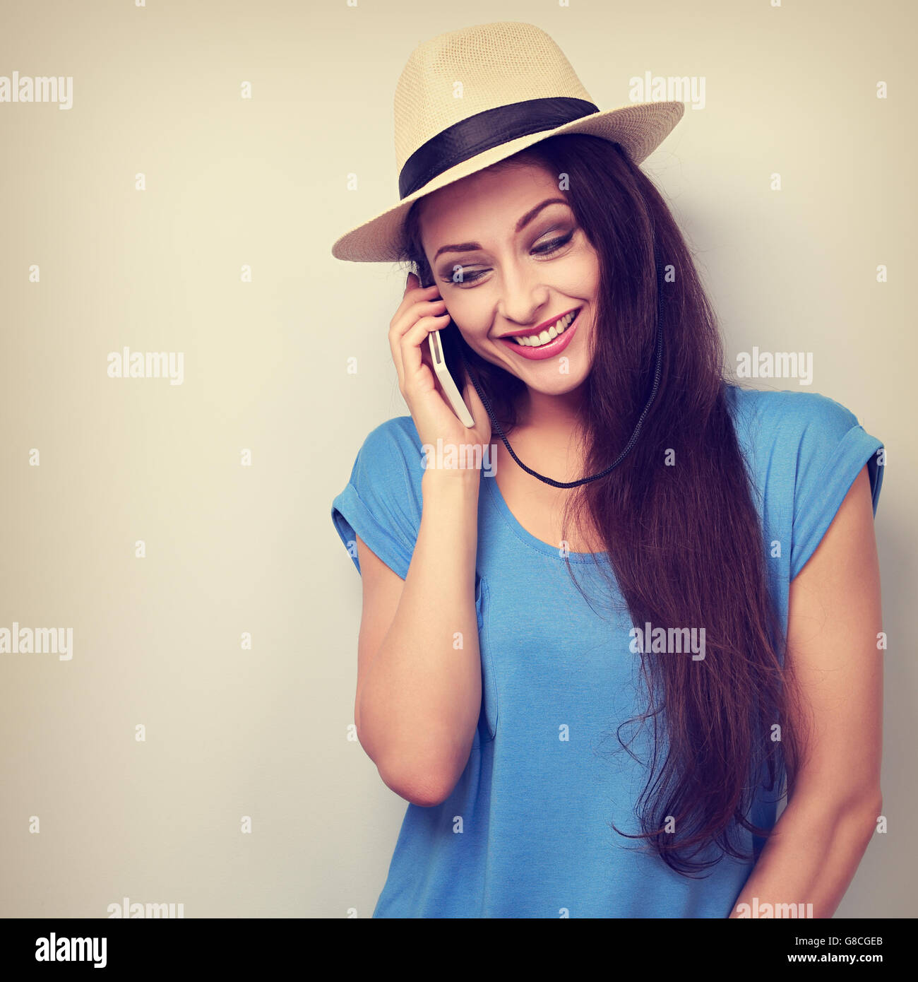 Fun laughing woman in hat speaking on mobile phone. Toned closeup portrait Stock Photo - Alamy