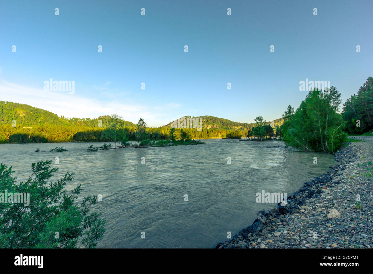 Small river with rocky shores flowing through a mountain valley Stock ...