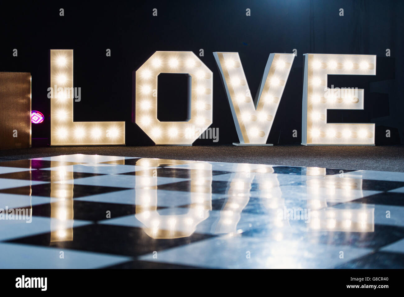Illuminated letters spelling "love" at a wedding reception Stock Photo ...