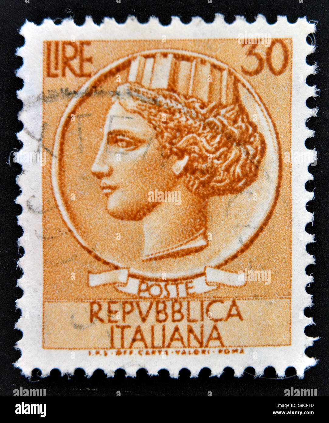 ITALY - CIRCA 1977: stamp printed in Italy shows head of a woman, who ...