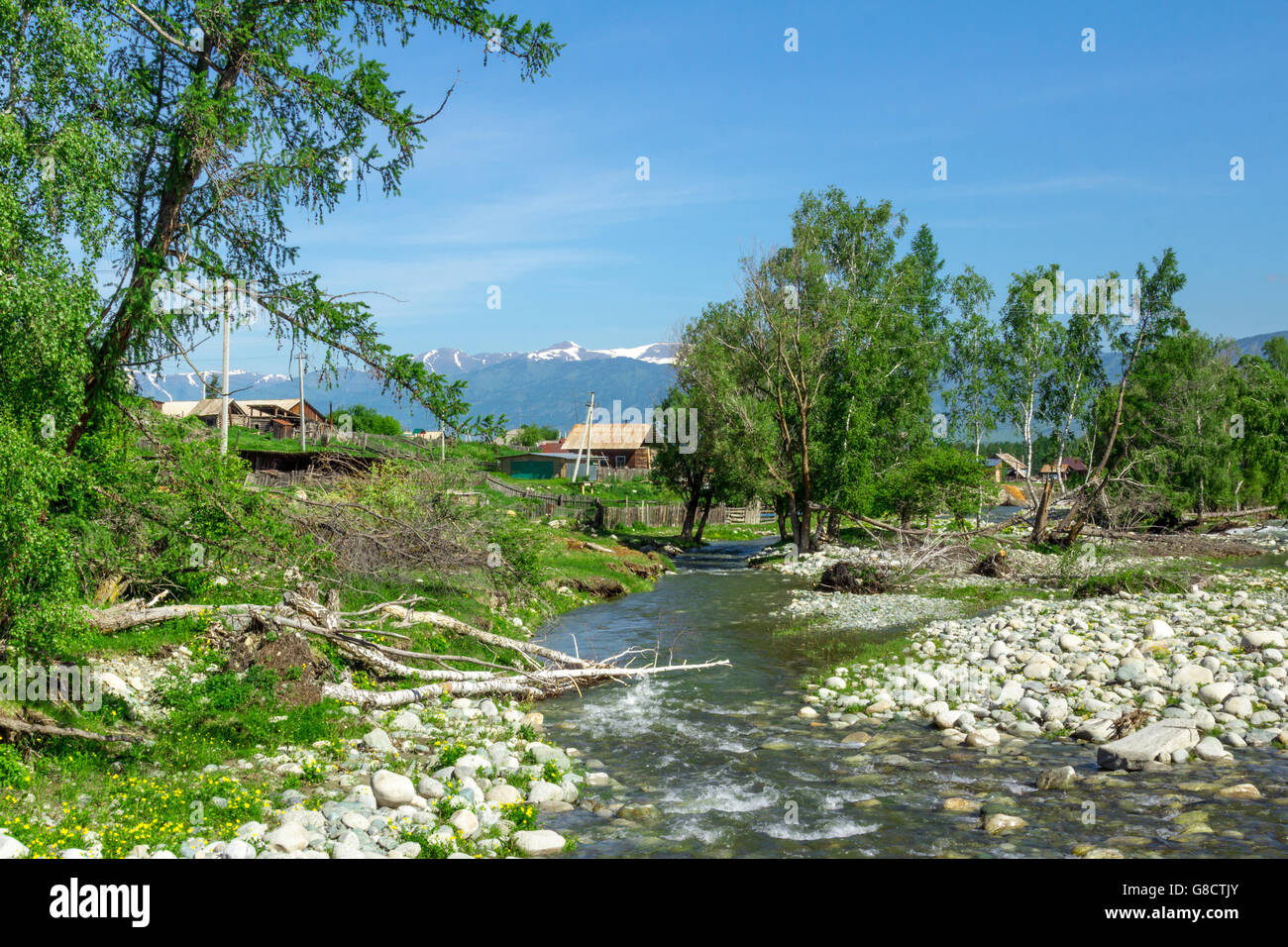 Small river with rocky shores flowing through a mountain valley Stock ...