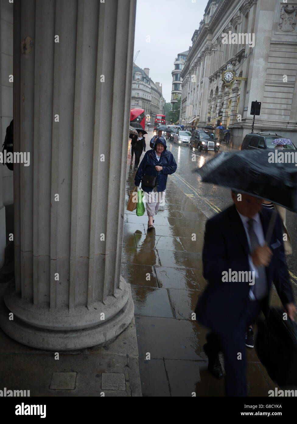 Rain wet weather outside the Bank of England in the financial district ...