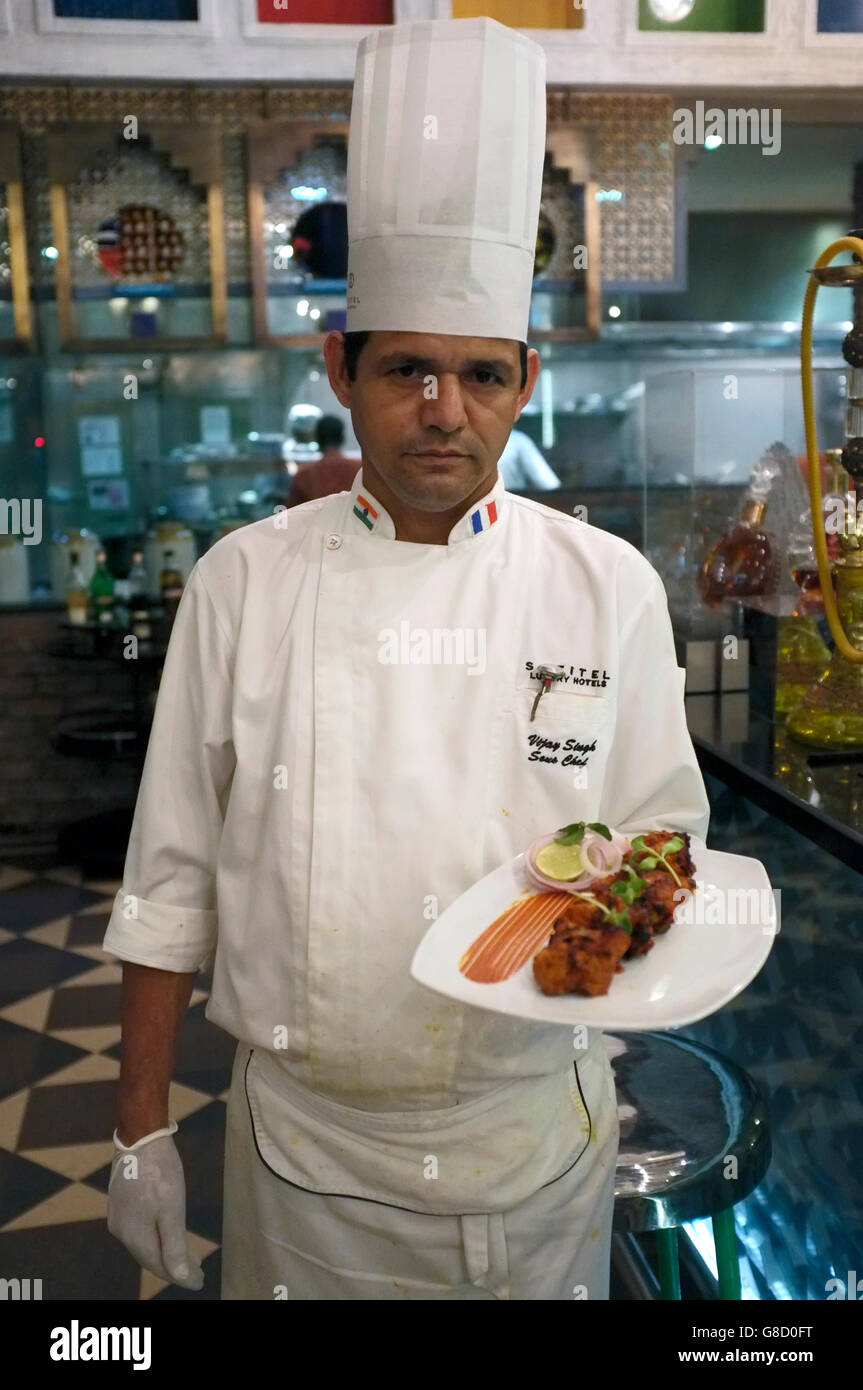 chefs prepare food at the kitchen in Jyran restaurant, north indian ...