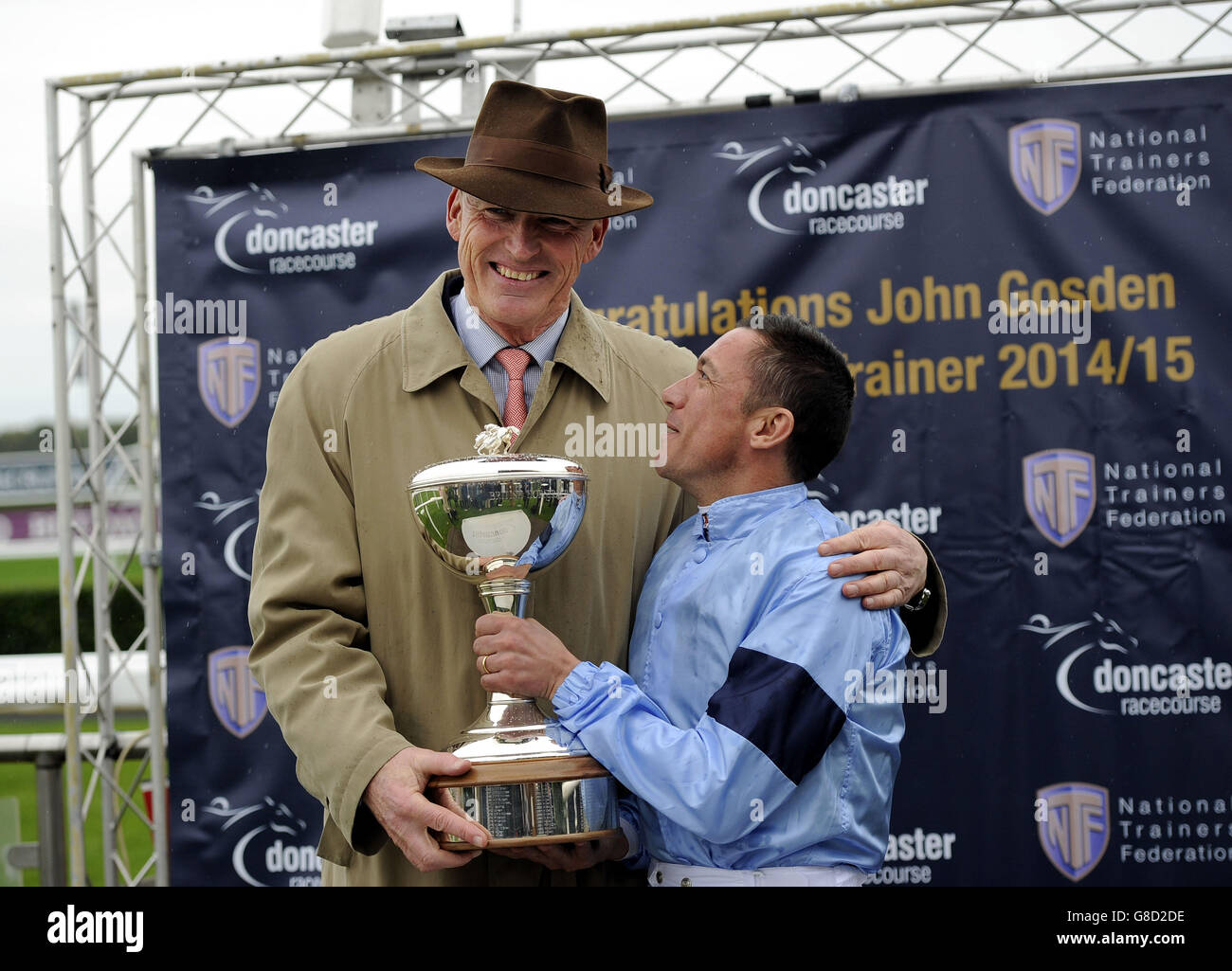 Trainer John Gosden receives the Trainers Flat Championship Trophy from ...