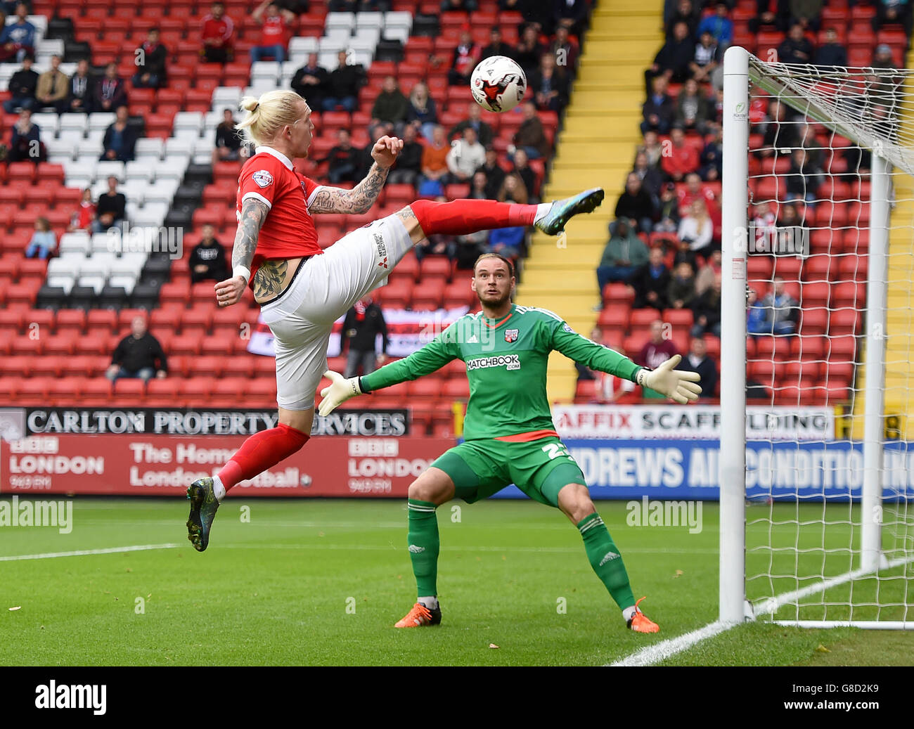 Charlton Athletic's Simon Makienok tries an acrobatic move as Brentford ...