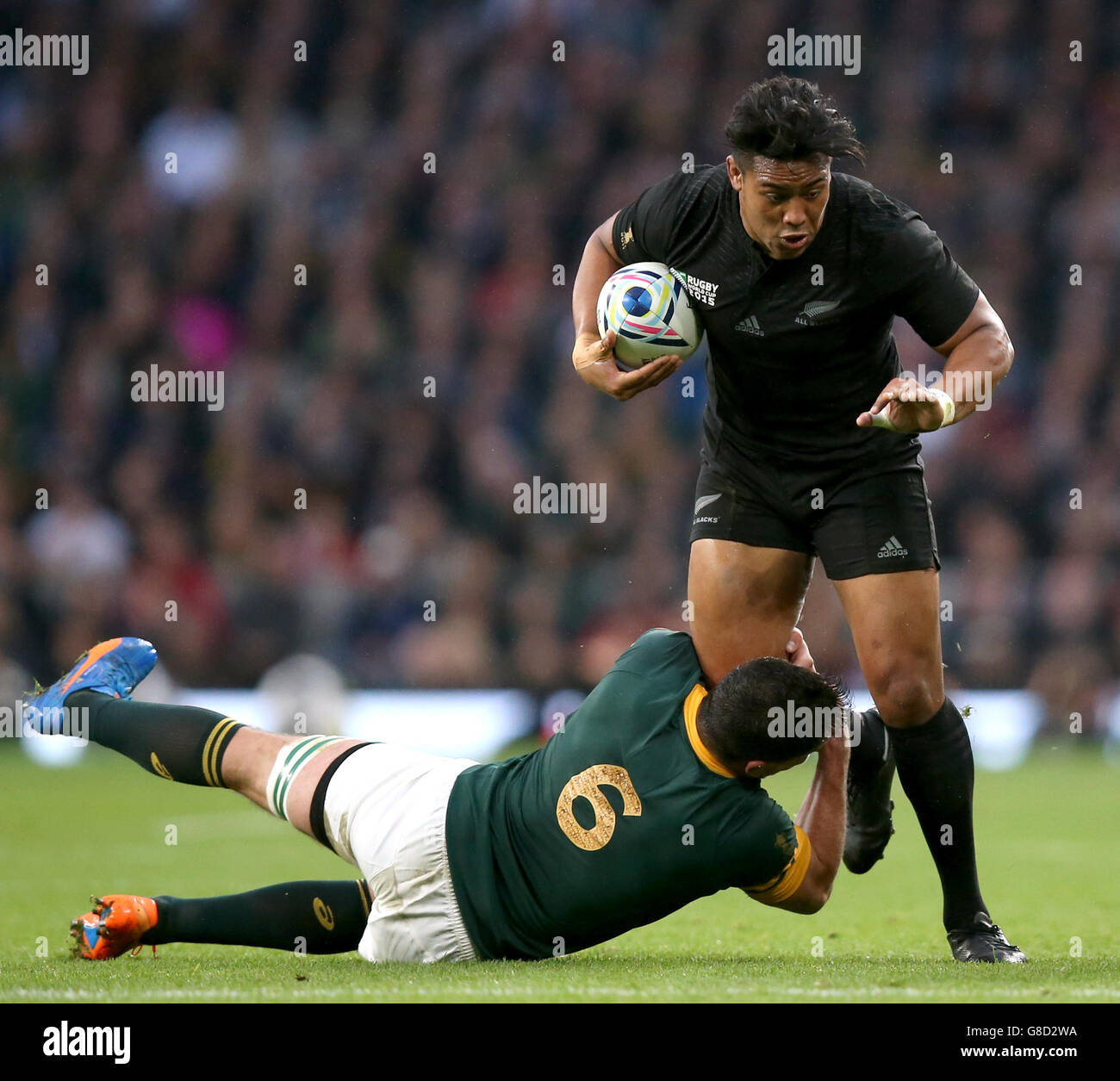 New Zealand's Julian Savea is tackled by South Africa's Francois Louw ...