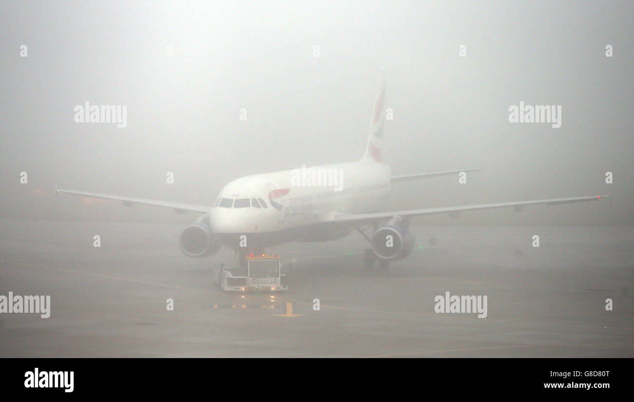 A British Airways plane in the fog at Terminal 5 of Heathrow Airport ...