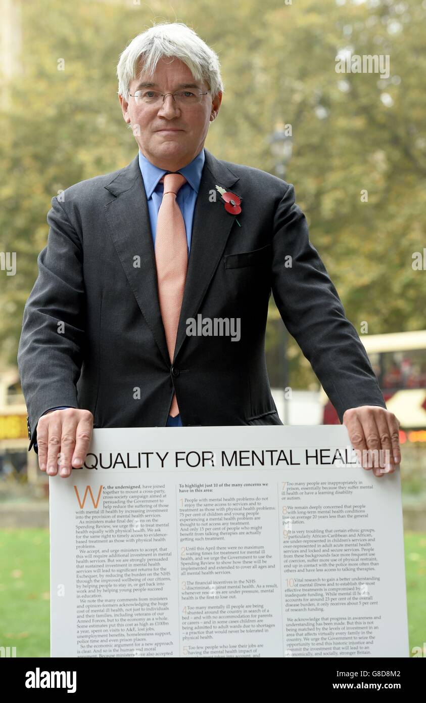 Andrew Mitchell stands outside the Houses of Parliament with a copy of ...