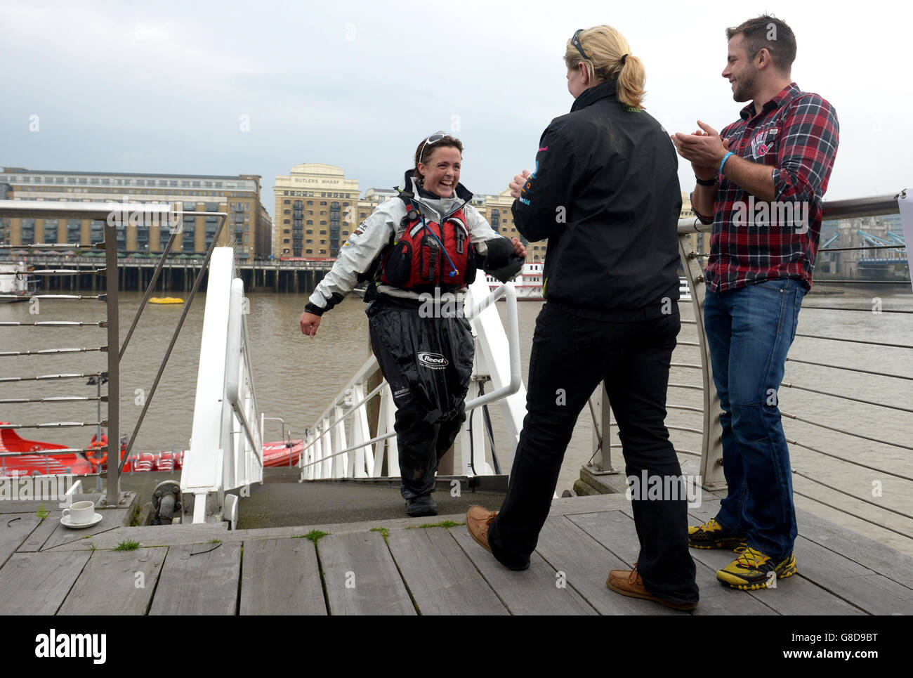British adventurer Sarah Outen (left) runs up the gangway to greet ...