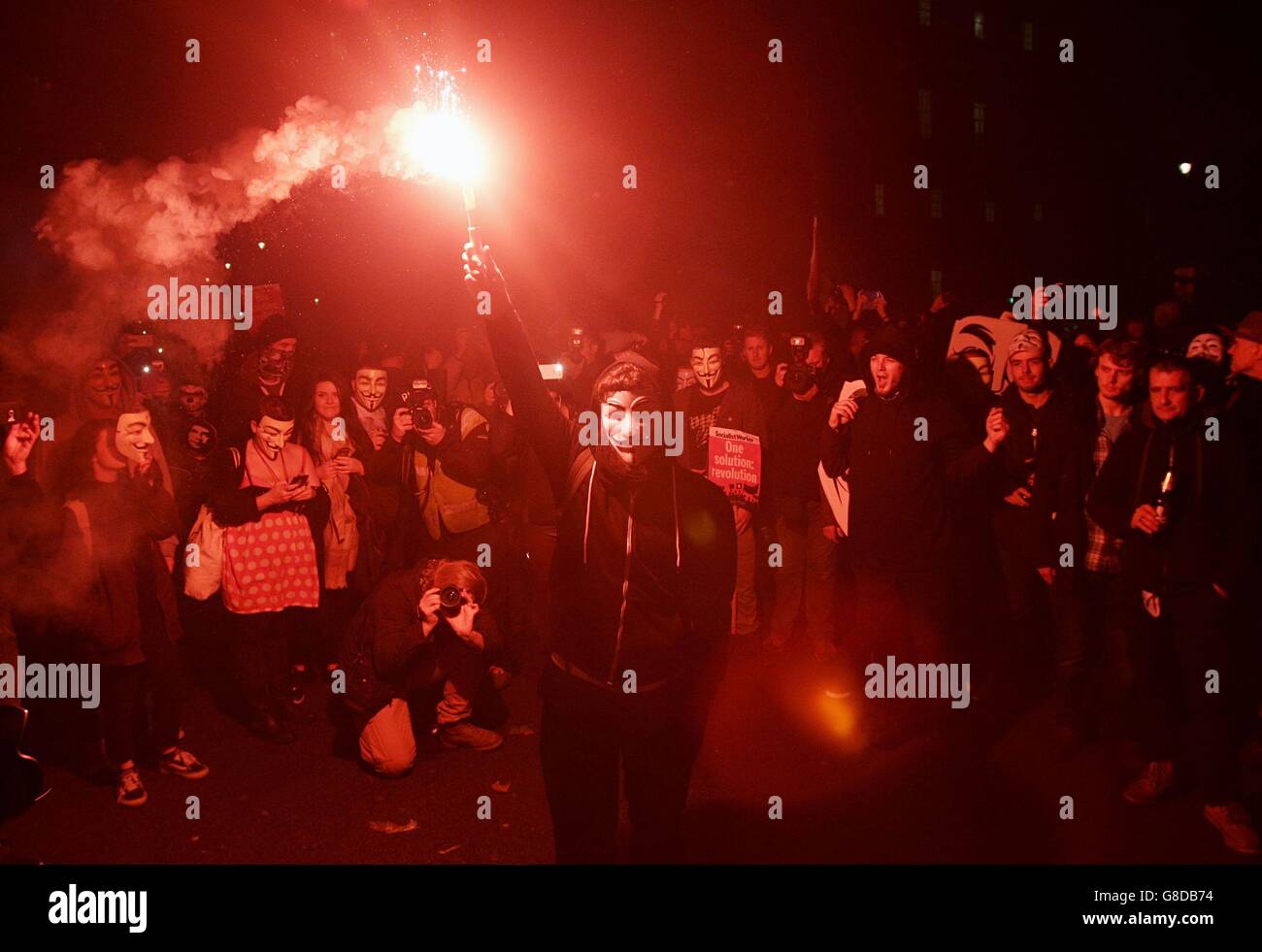 A protester with a flare demonstrates near Parliament Square, London ...