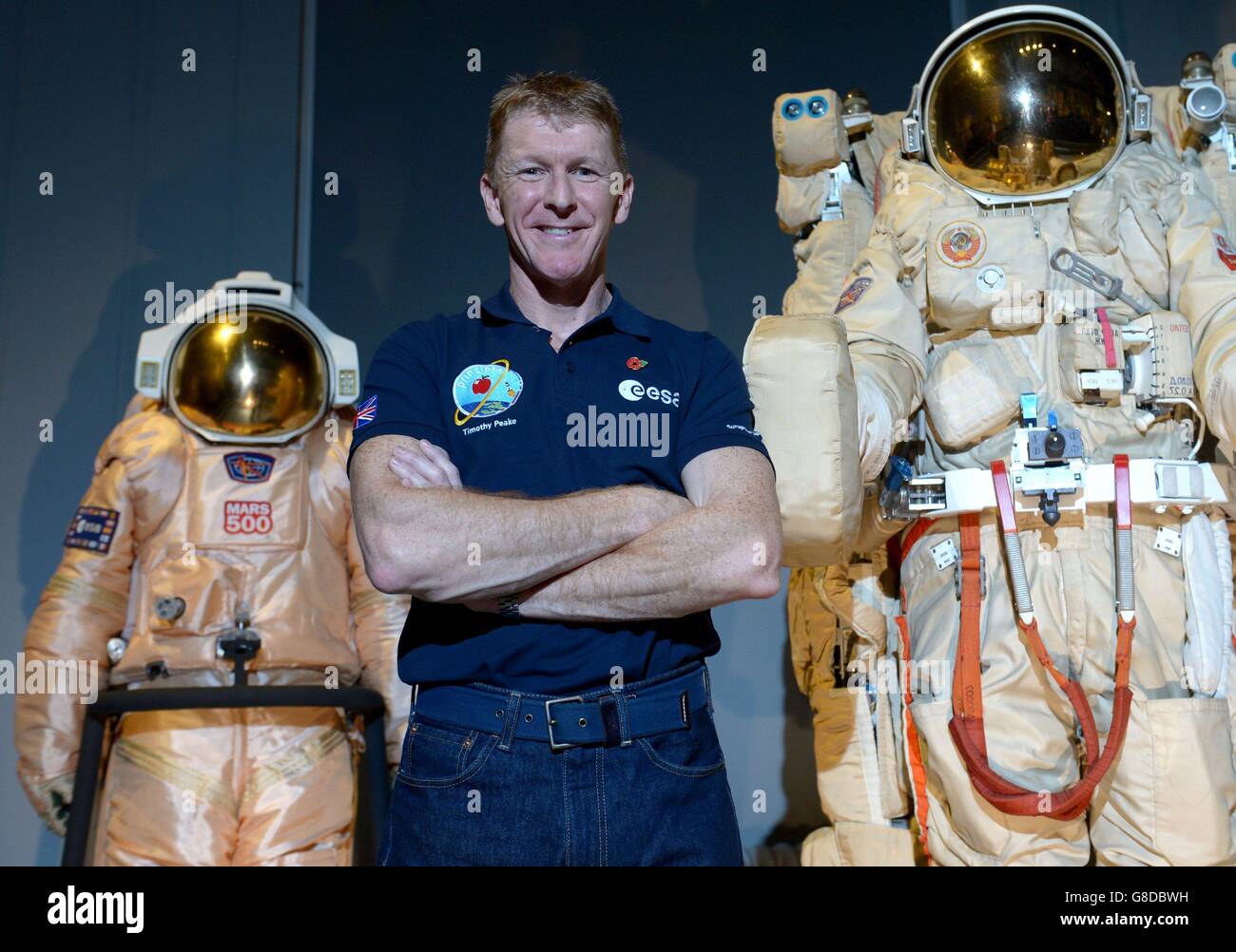 British astronaut Tim Peake poses beside spacesuits as he talks to UK ...