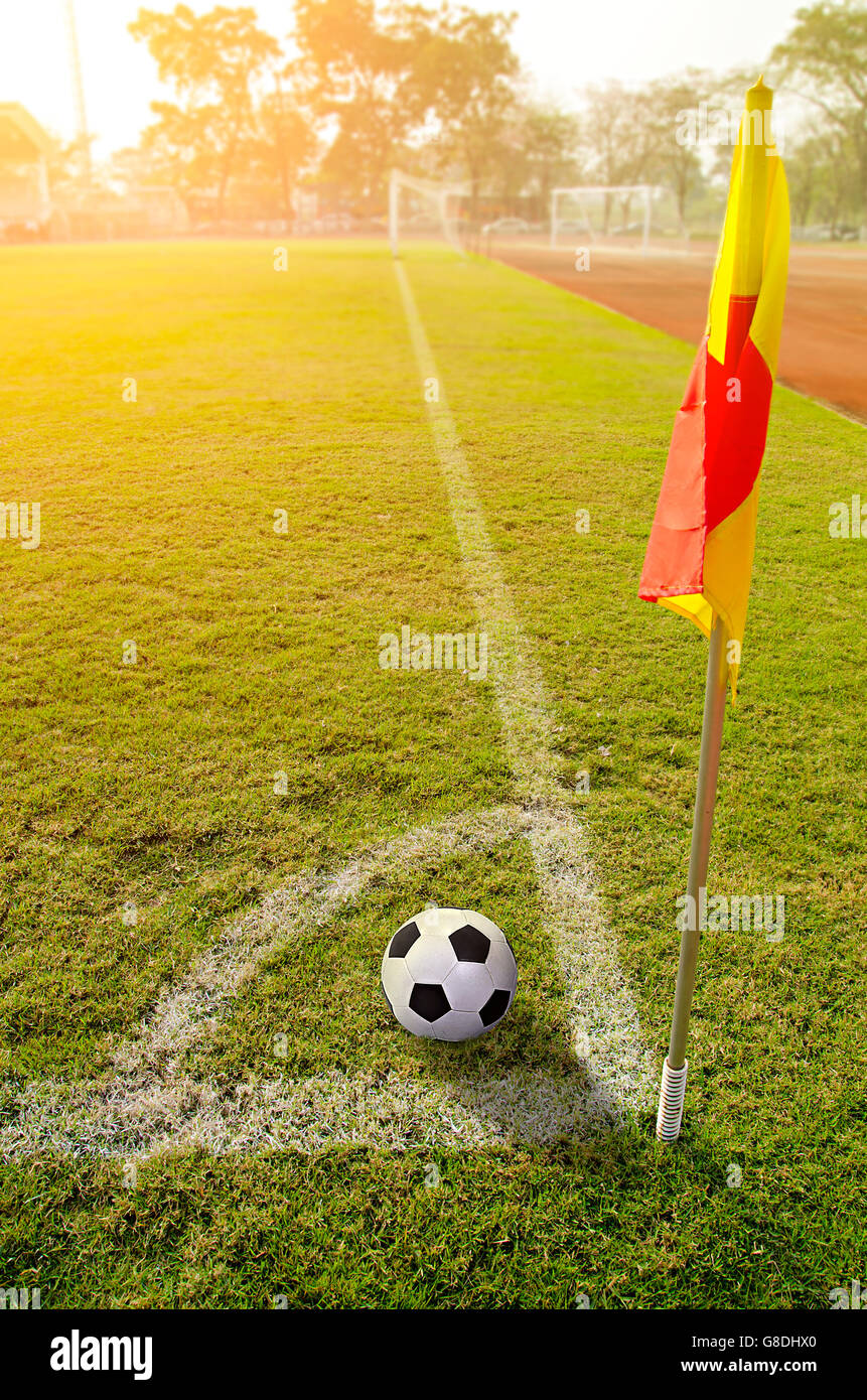 Corner flag with ball on a soccer field Stock Photo - Alamy
