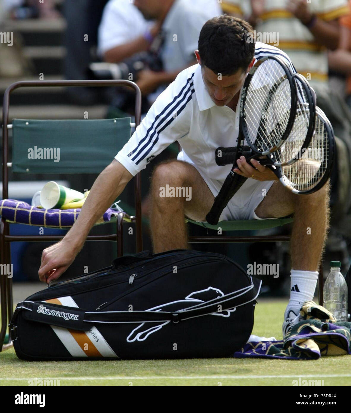 Great Britain's Tim Henman packs up his rackets after losing Stock ...