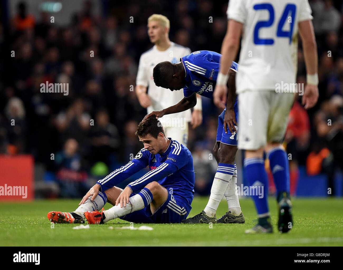Chelsea's Oscar sits on the pitch as Chelsea's Ramires (right) speaks ...