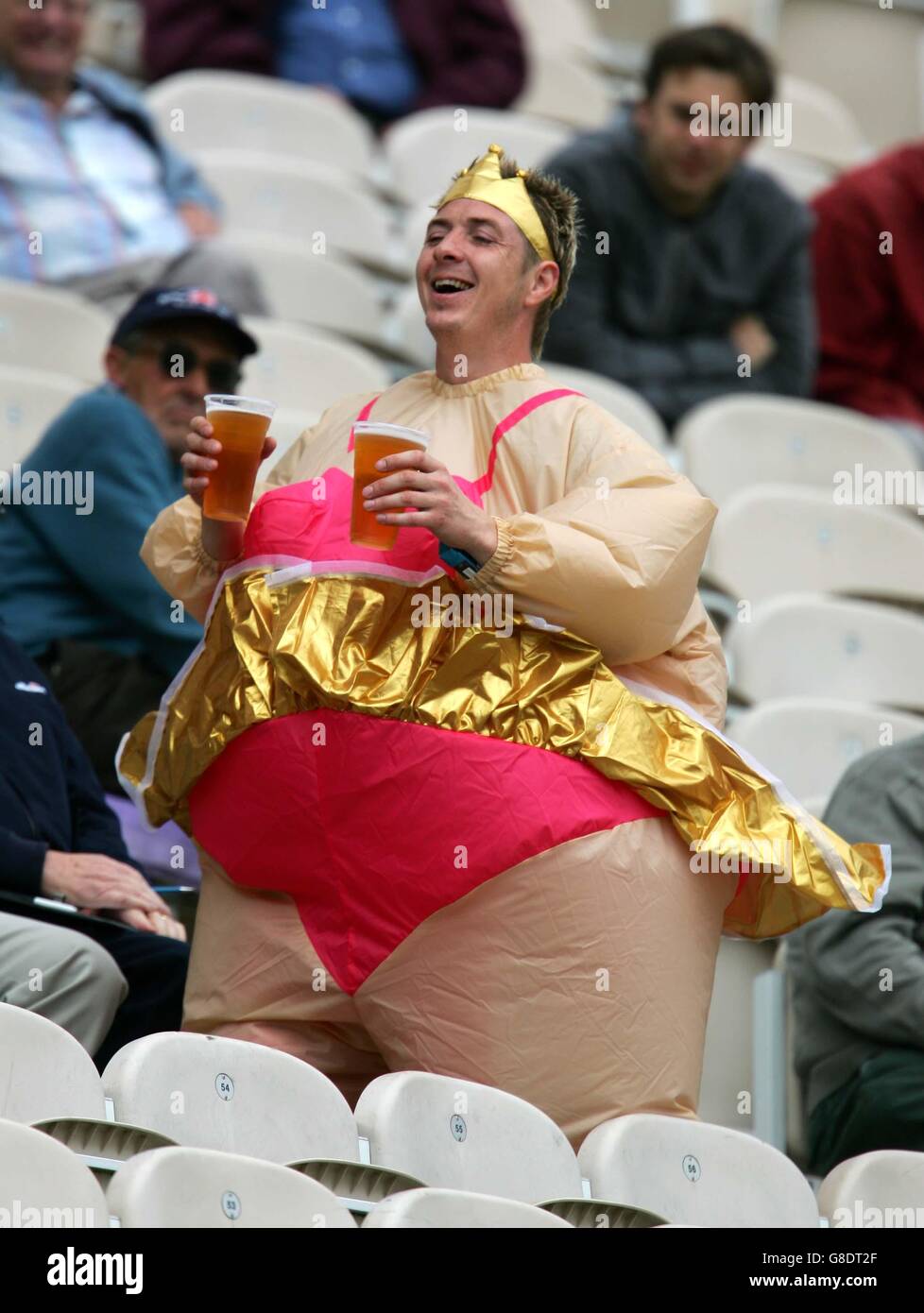 A fan buys the beers wearing a fat-man's fancy dress outfit Stock Photo ...