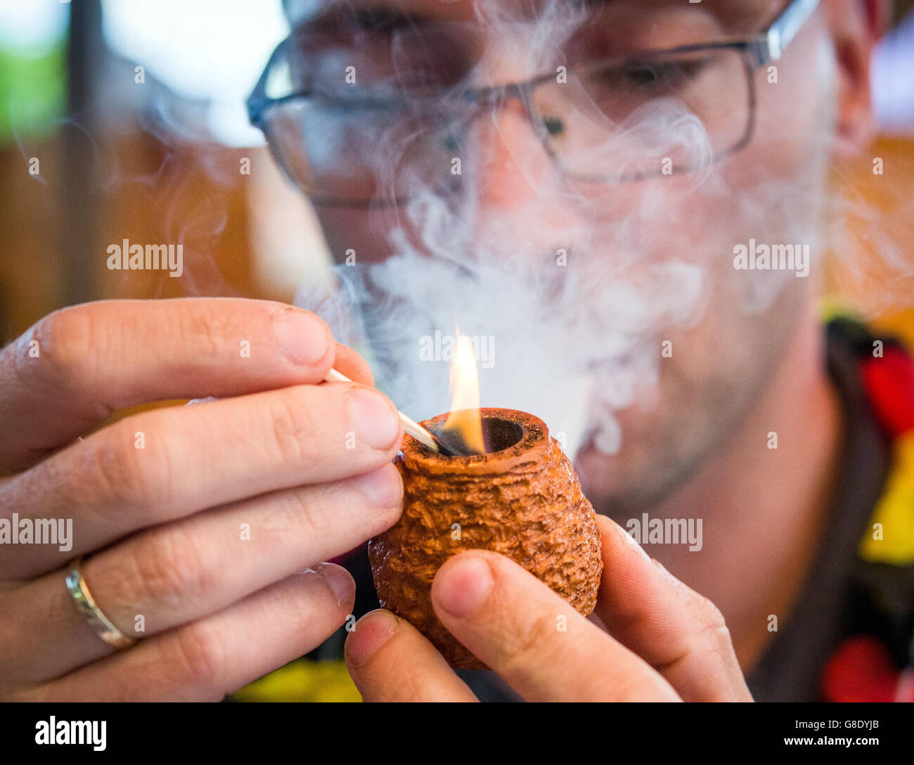 Members of the Pipe-Club-Wriezen competing in smoking a pipe as slow as ...
