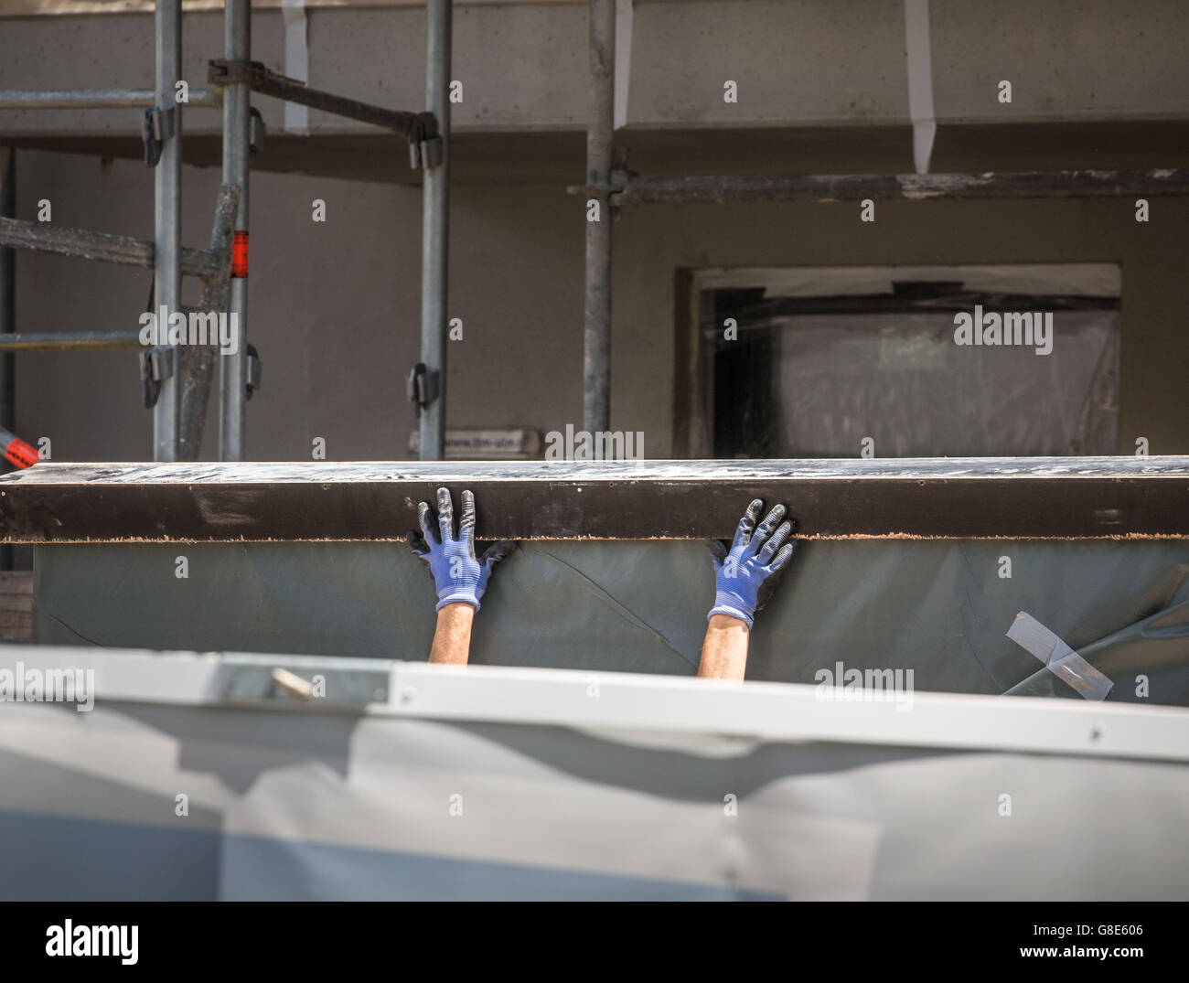 A construction worker holds a casing on the construction site of an ...
